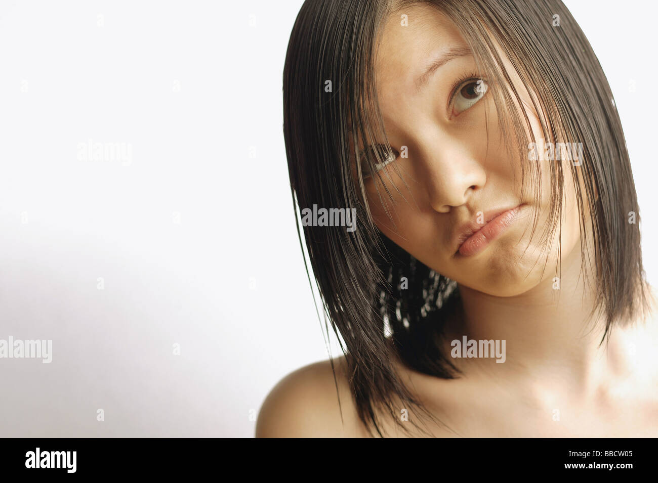 Young woman making a face, looking up Stock Photo - Alamy