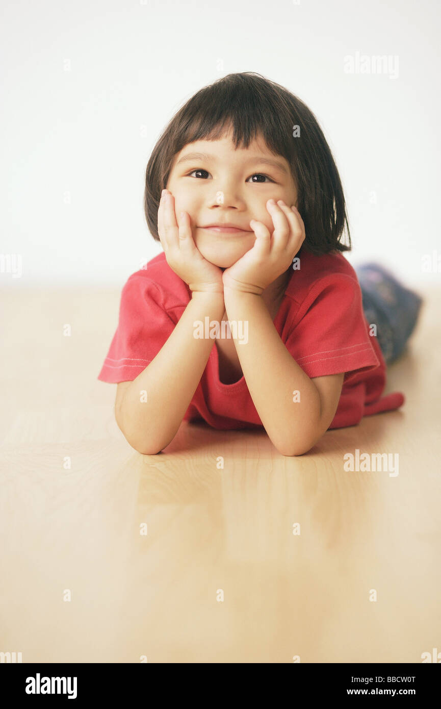 Young girl with hands on chin Stock Photo - Alamy
