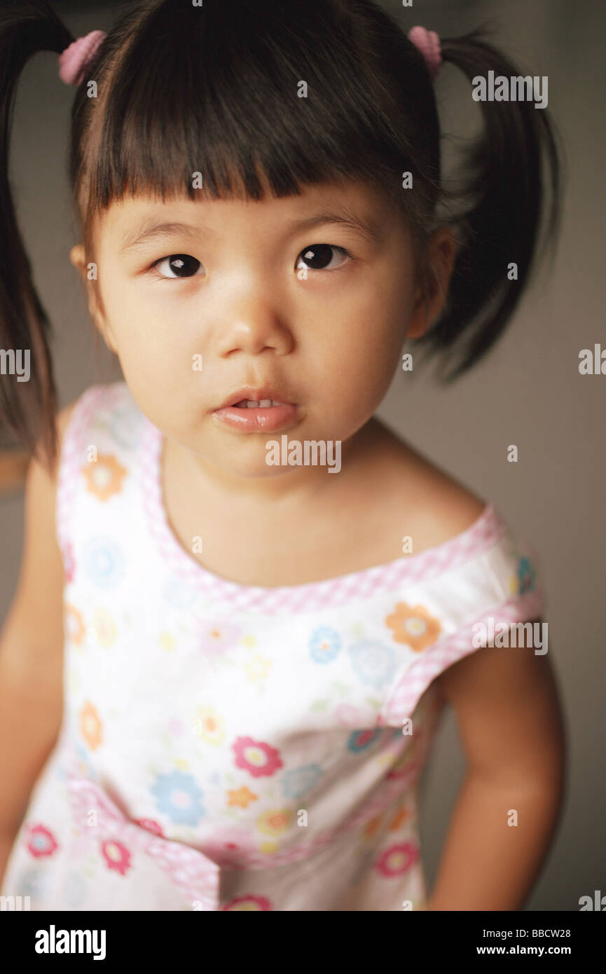 Young girl, looking up at camera, portrait Stock Photo - Alamy
