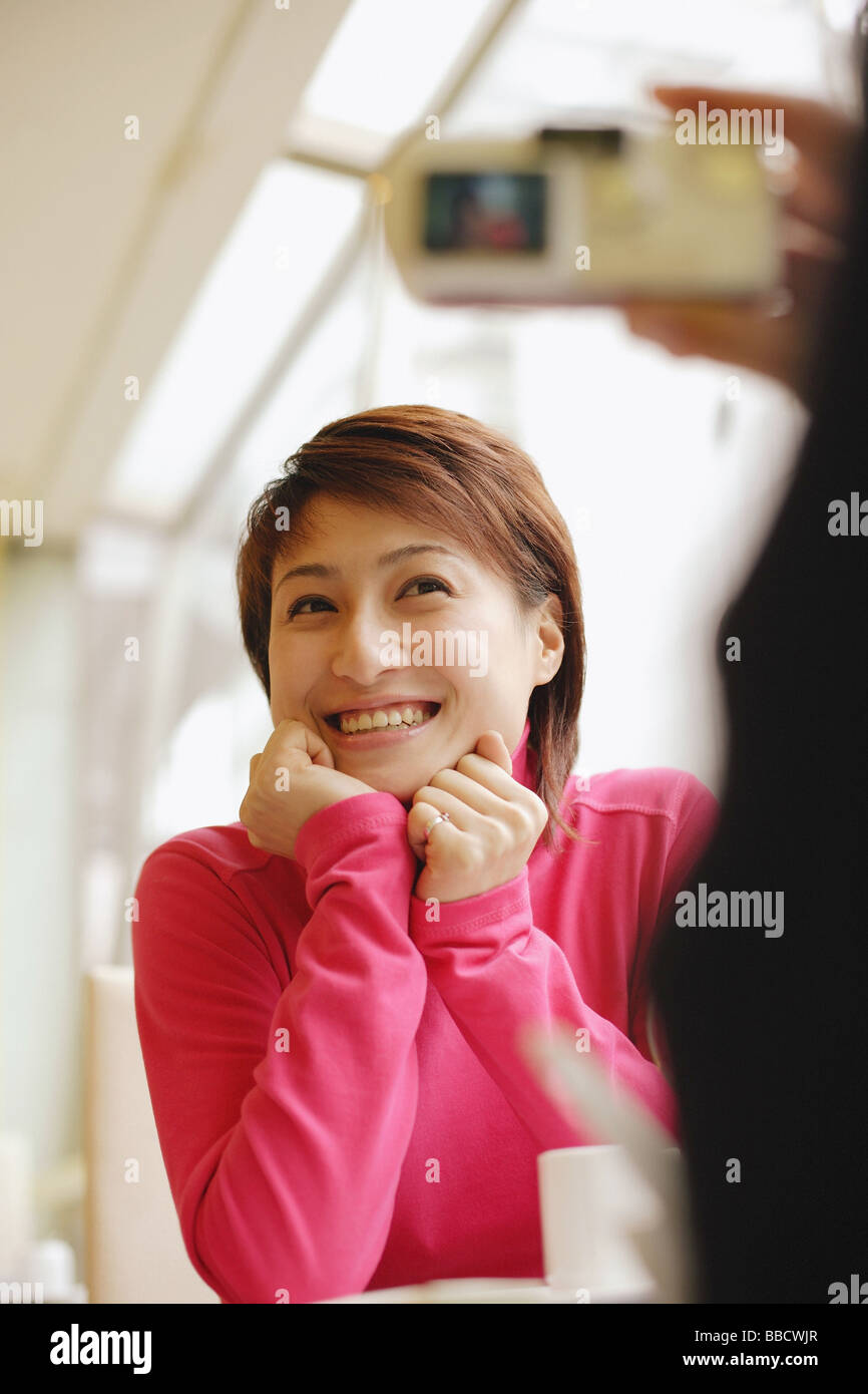 Young woman posing while another person takes her picture Stock Photo ...