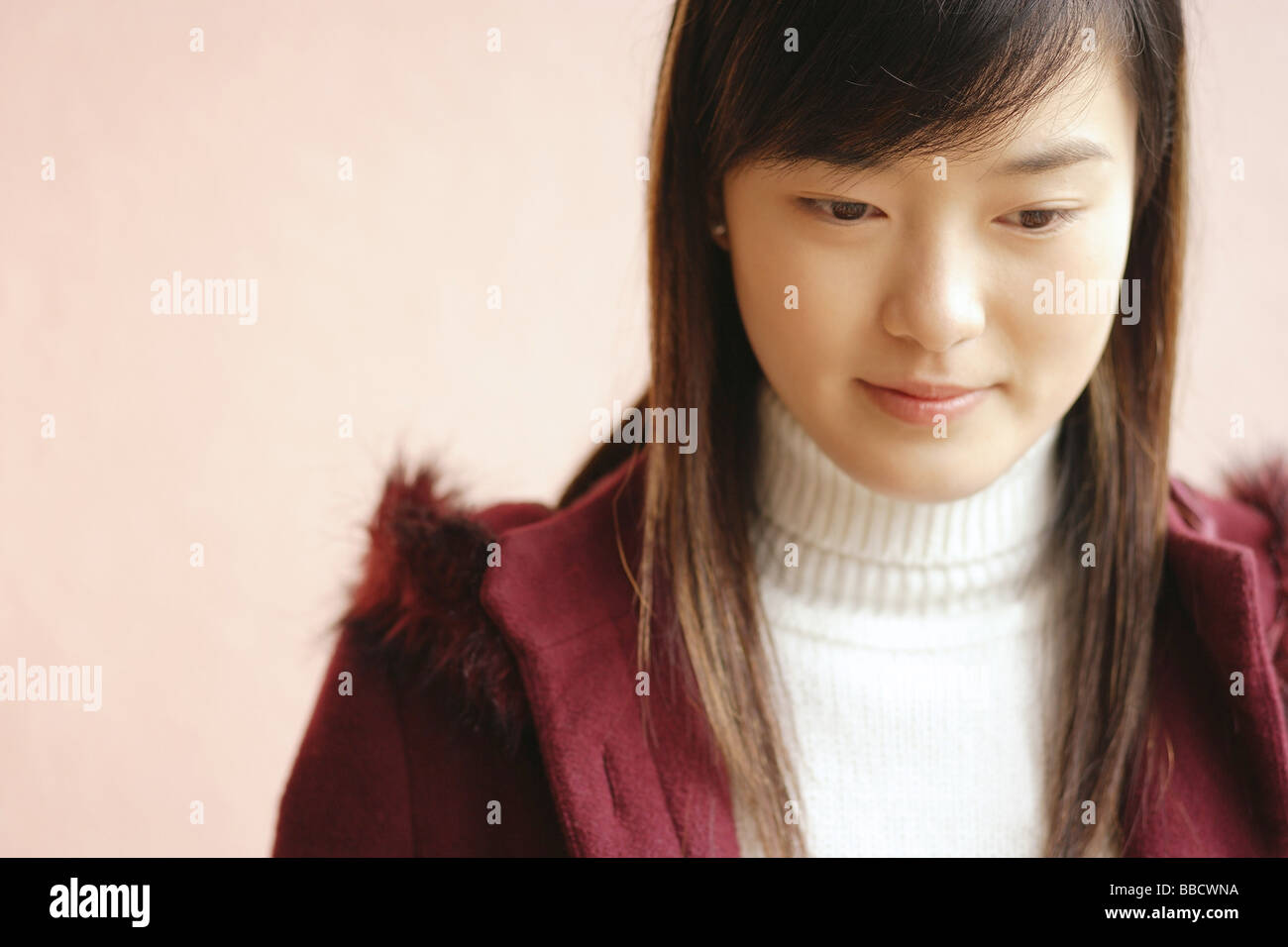 Young woman looking down, portrait Stock Photo - Alamy