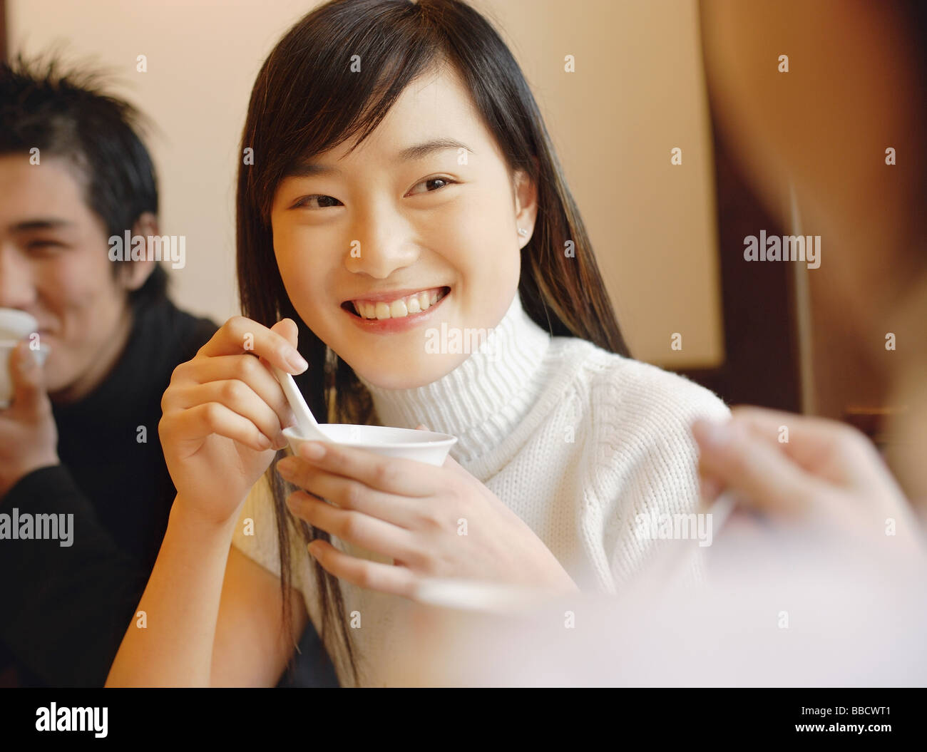 Friends eating soup, smiling Stock Photo - Alamy