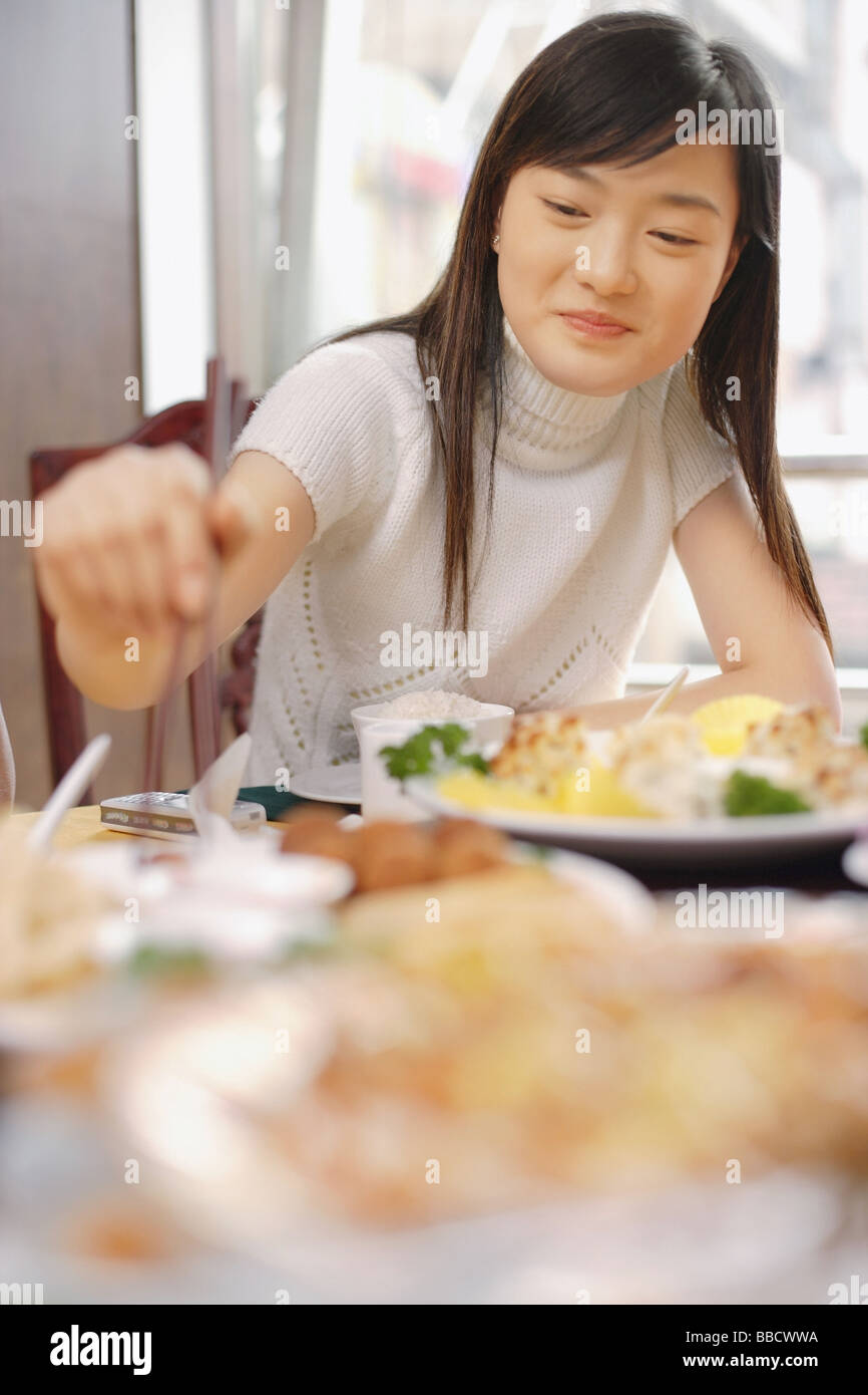 Young woman at a Chinese restaurant, eating Stock Photo - Alamy