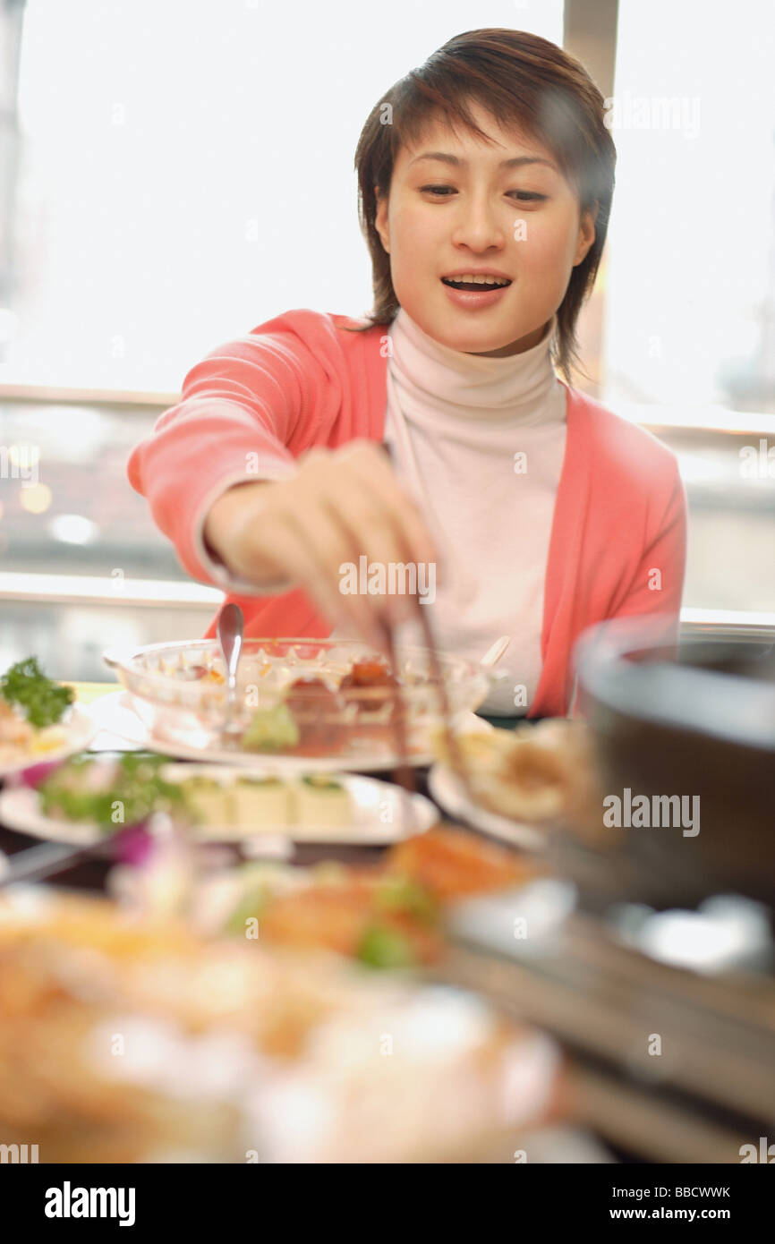 Young woman at a Chinese restaurant, eating Stock Photo - Alamy