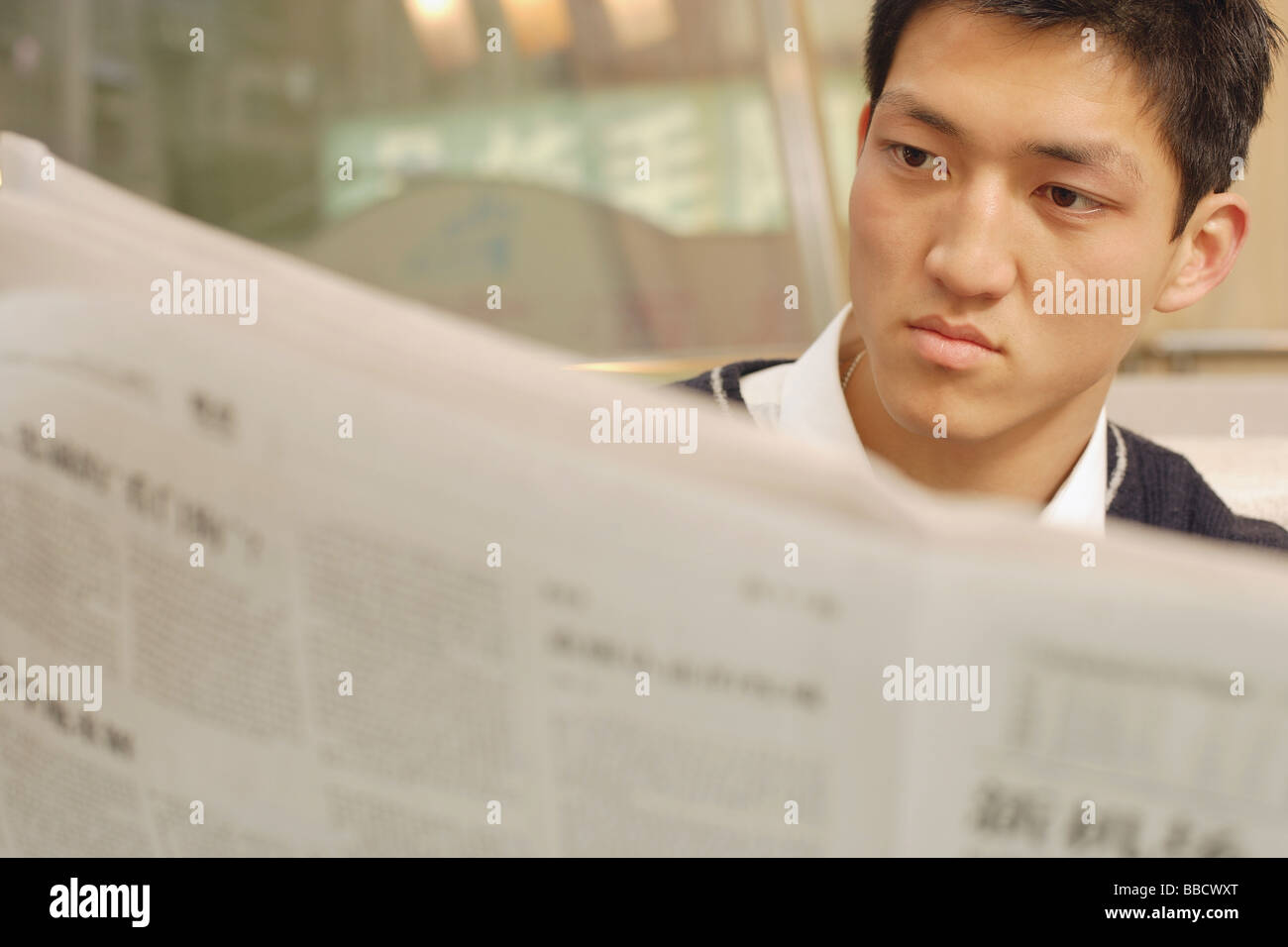 Young man reading newspaper Stock Photo - Alamy Young man reading newspaper Stock Photo - Alamy