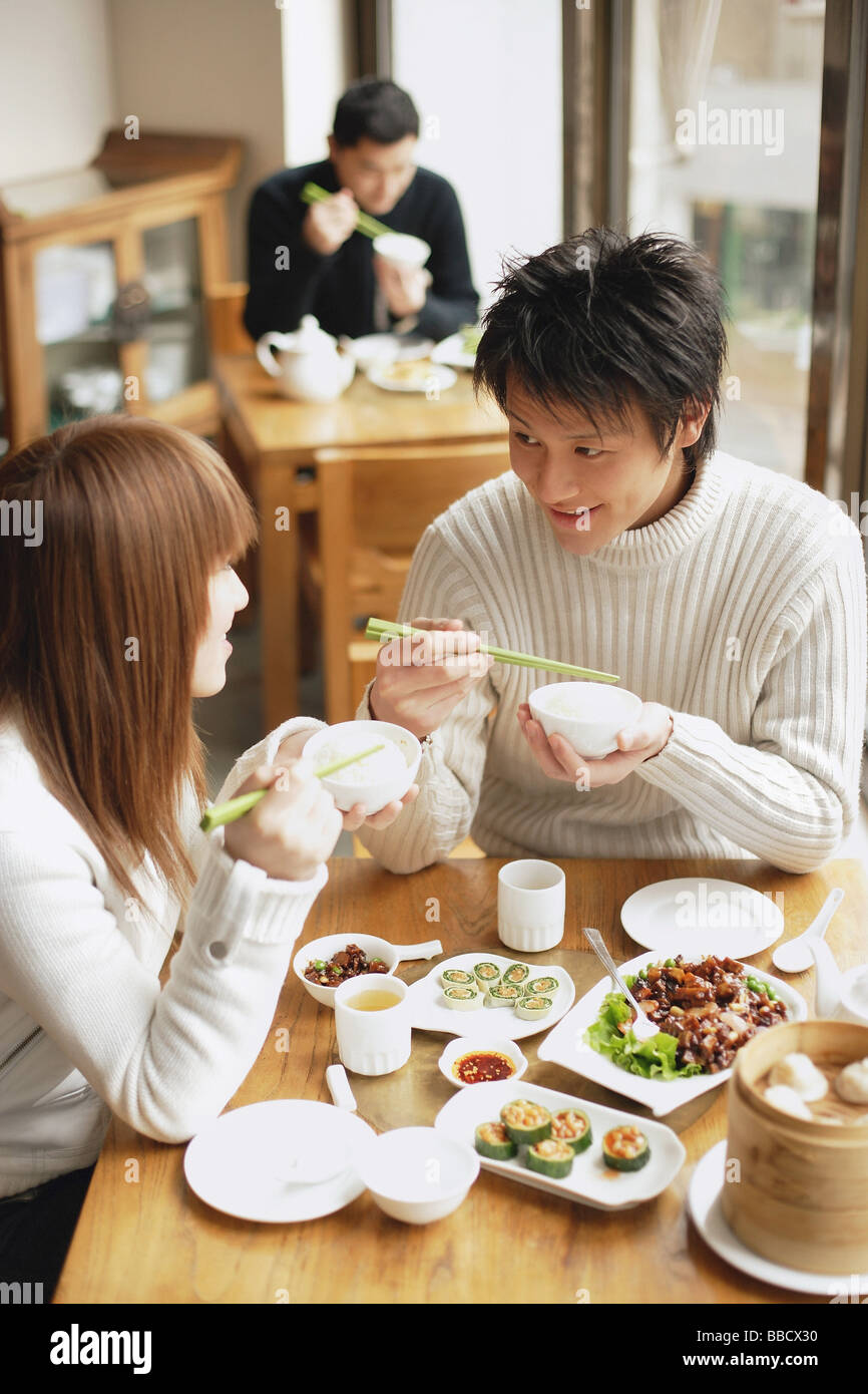 Young adults eating at a restaurant Stock Photo - Alamy