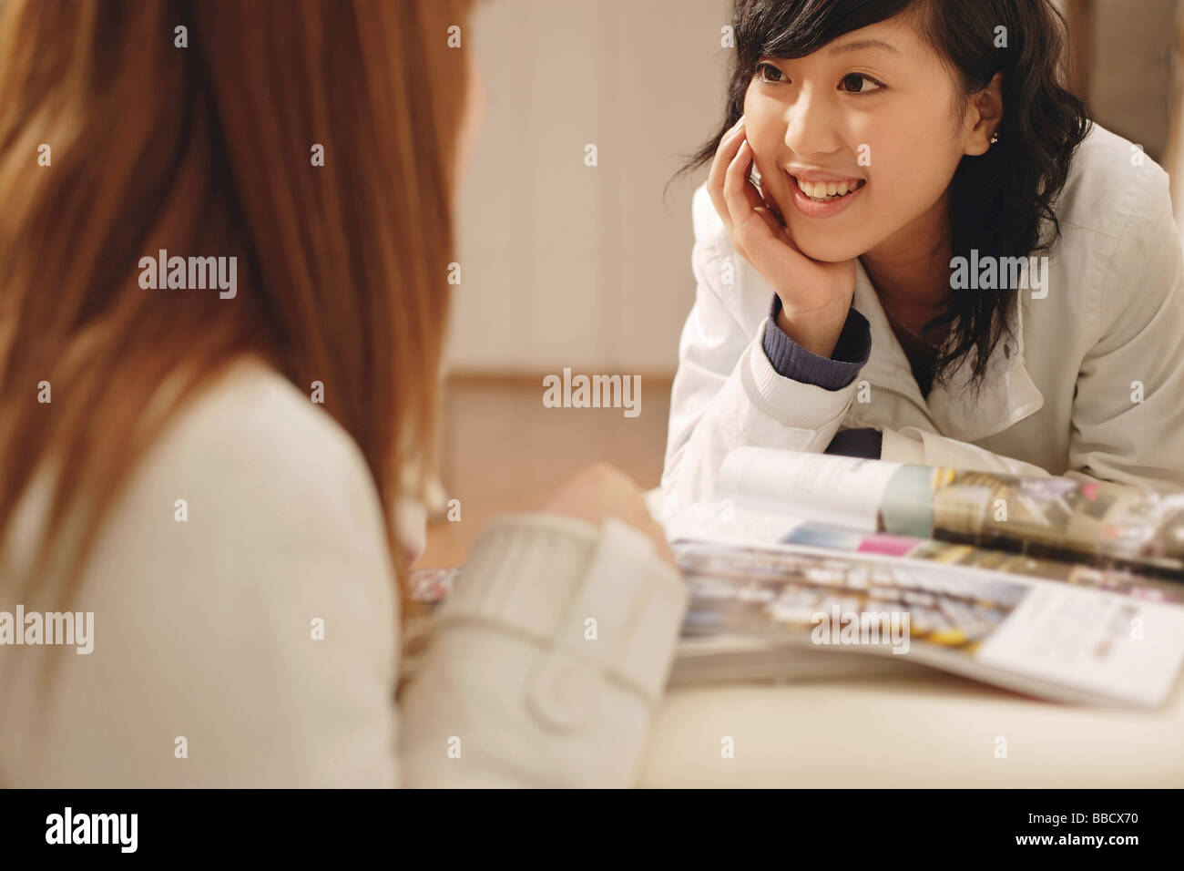 Two young women talking, face to face Stock Photo - Alamy