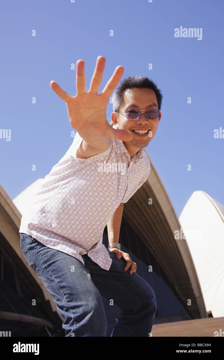 Young man showing palm of hand, low angle view Stock Photo - Alamy