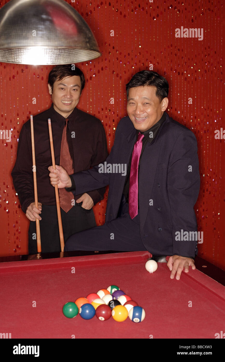 Two businessmen at pool table Stock Photo - Alamy