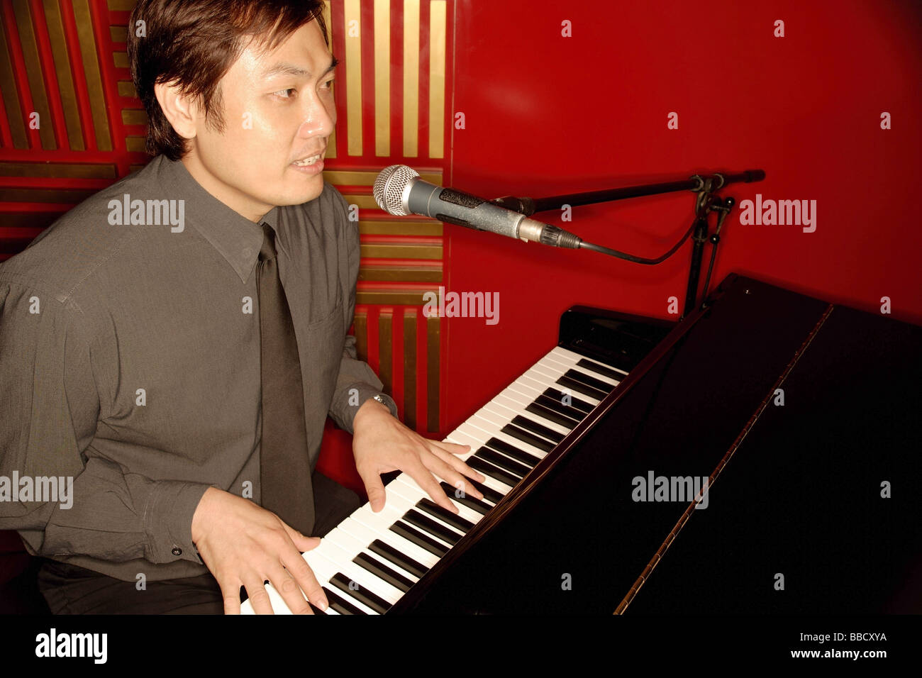 Asian man sitting piano hi-res stock photography and images - Alamy