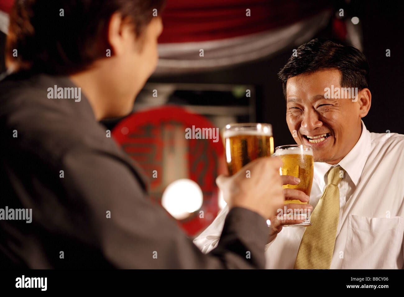 Two men drinking beer together Stock Photo - Alamy