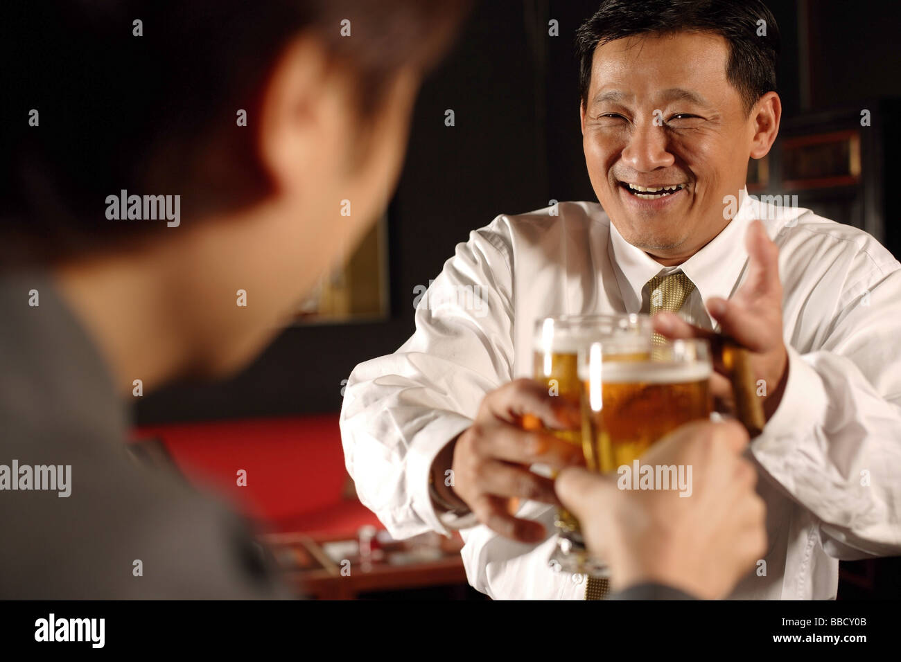 Two men toasting with beer glasses Stock Photo - Alamy