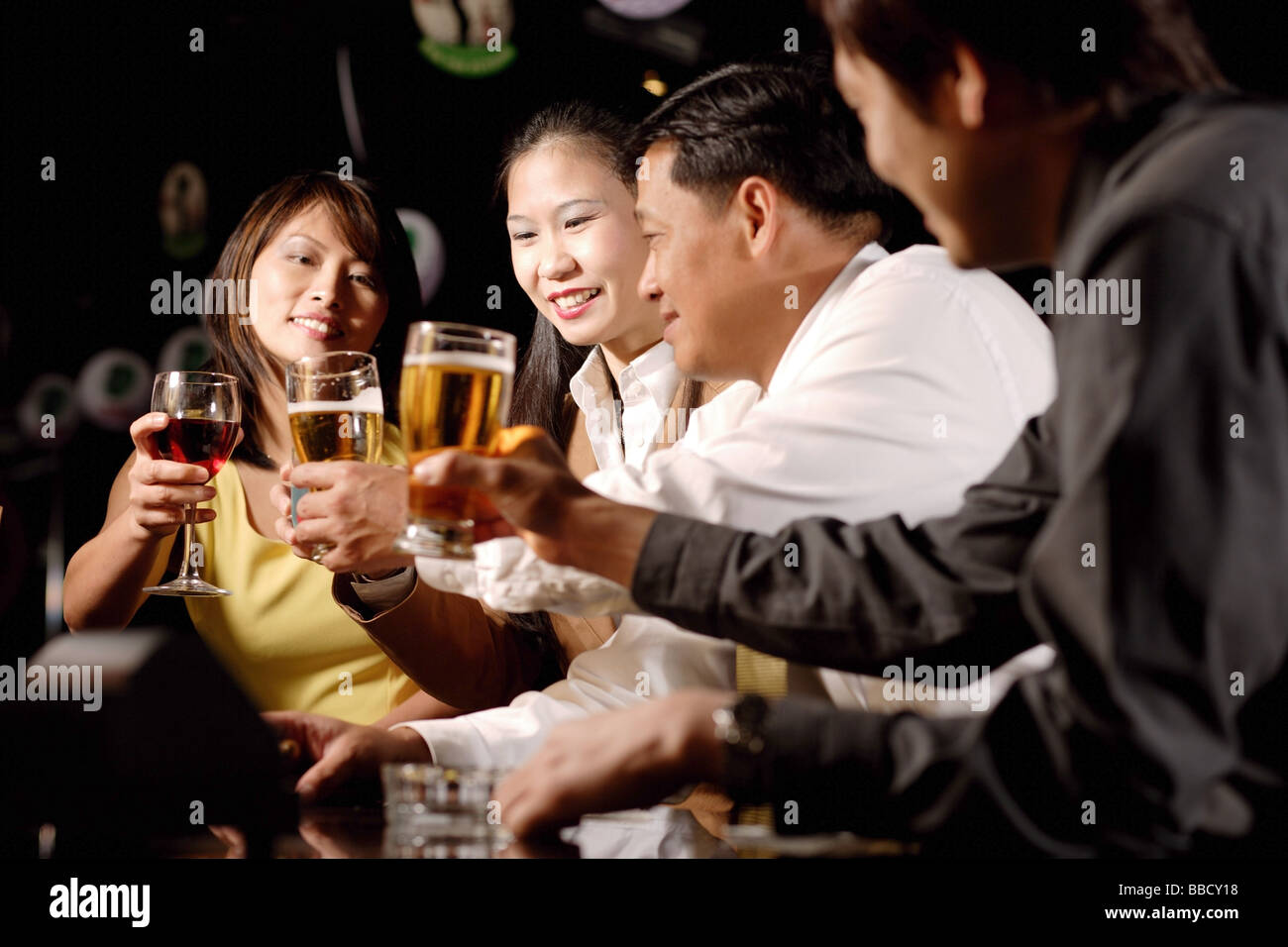 Couples toasting with drinks Stock Photo - Alamy