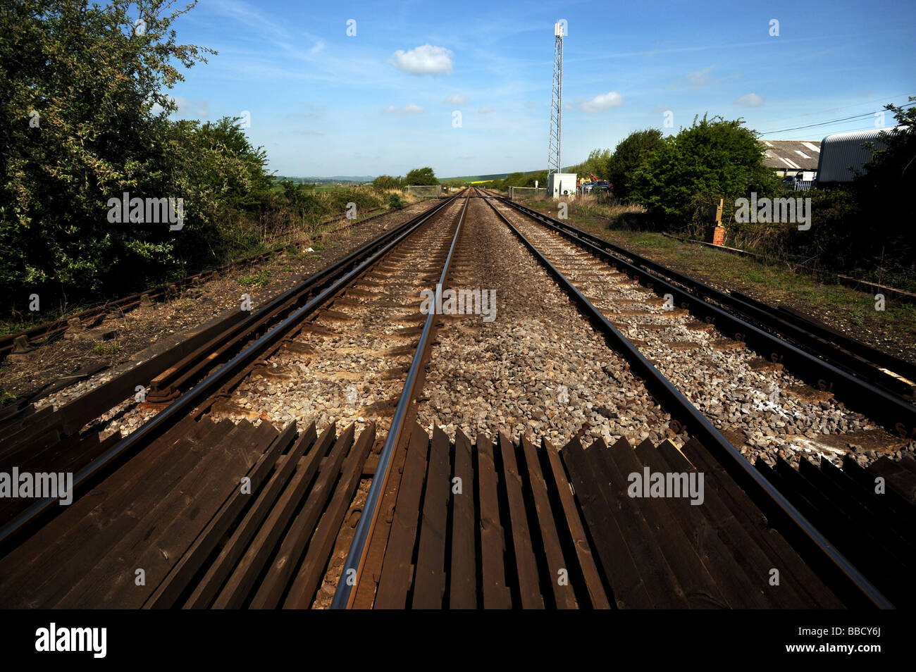 Train tracks heading off into a blue sky Stock Photo - Alamy