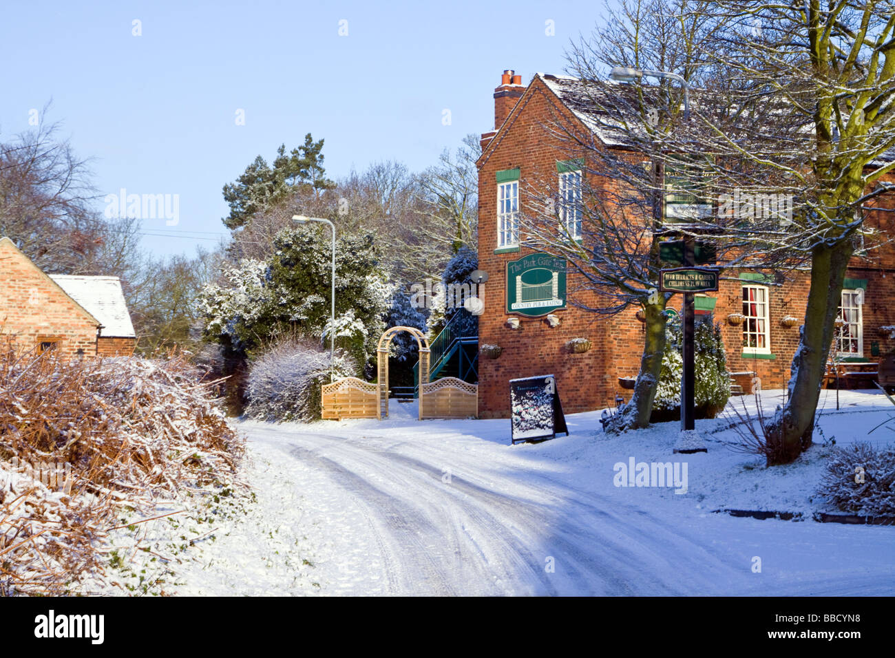 Snow covered country lane after heavy snow fall winter Park Gate Inn ...