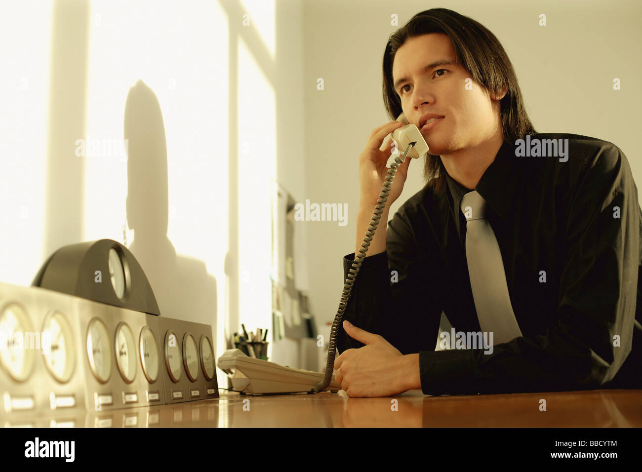 Executive sitting on desk in hi-res stock photography and images - Alamy