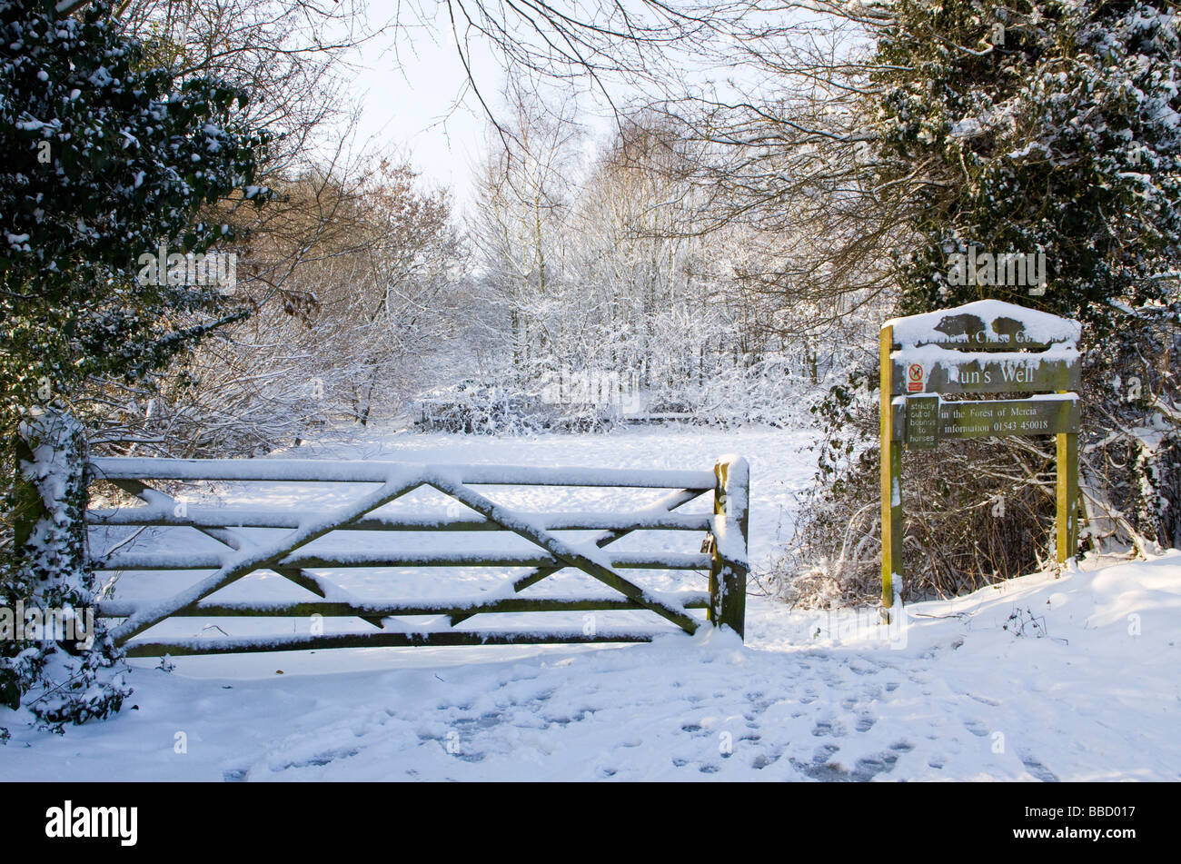Five barred gate car park at Castle Ring snow covered trees in winter ...