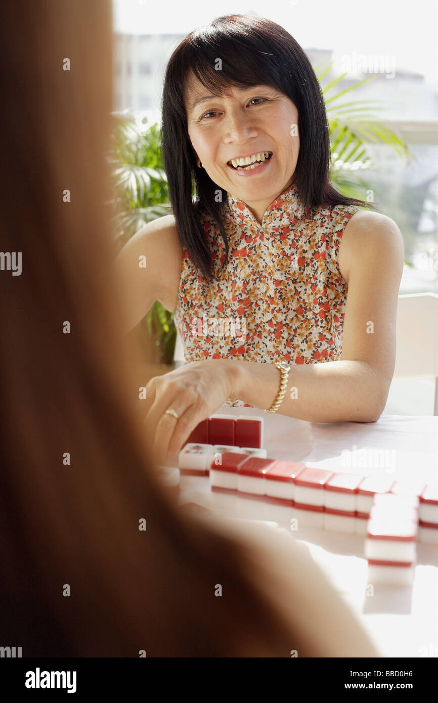 Woman playing mahjong, portrait Stock Photo - Alamy