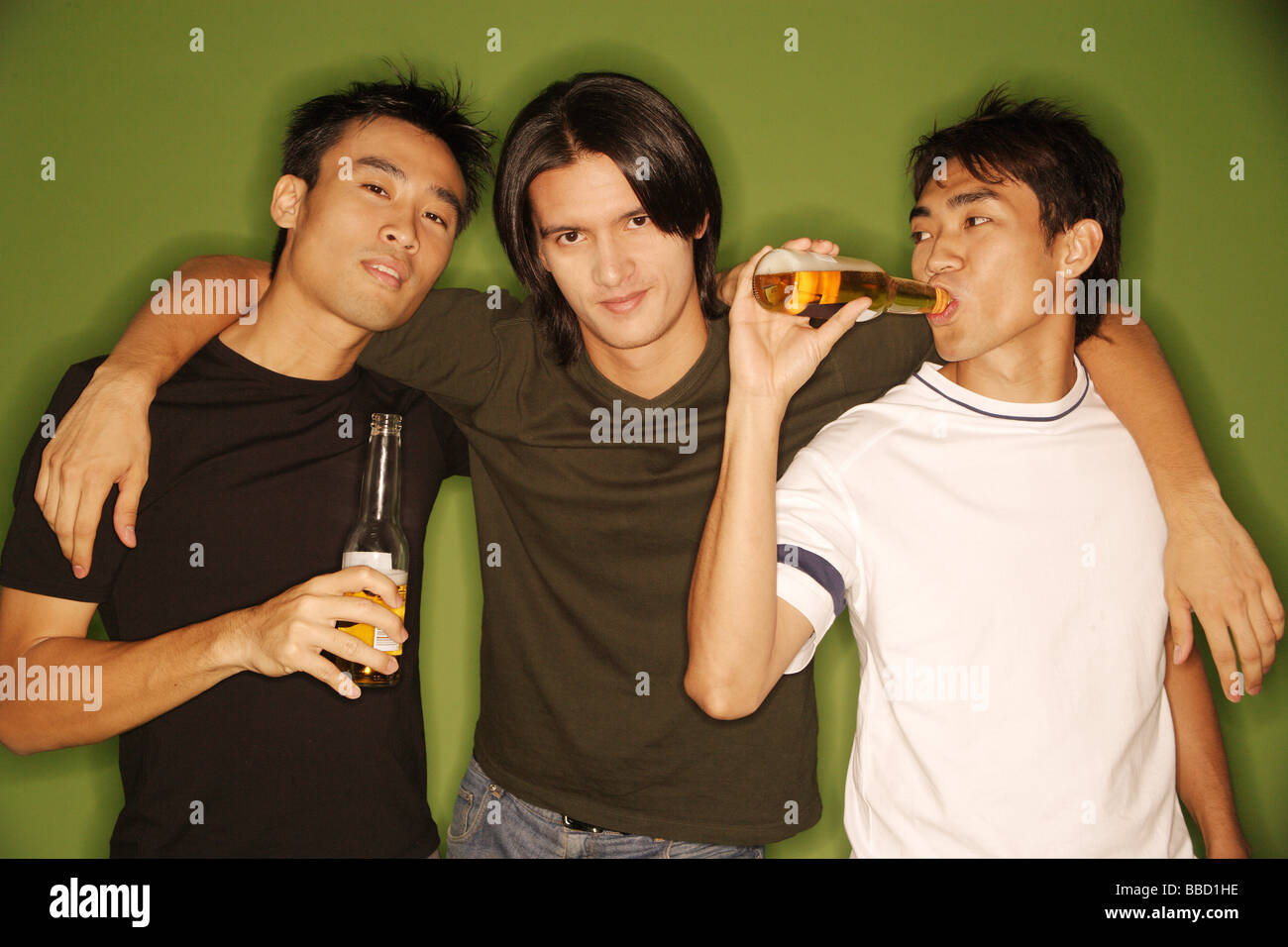 Three young men, arm around each other, facing camera Stock Photo - Alamy