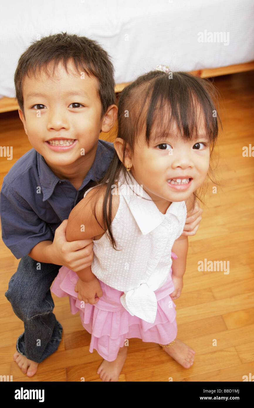 Young children, looking up at camera, smiling Stock Photo - Alamy