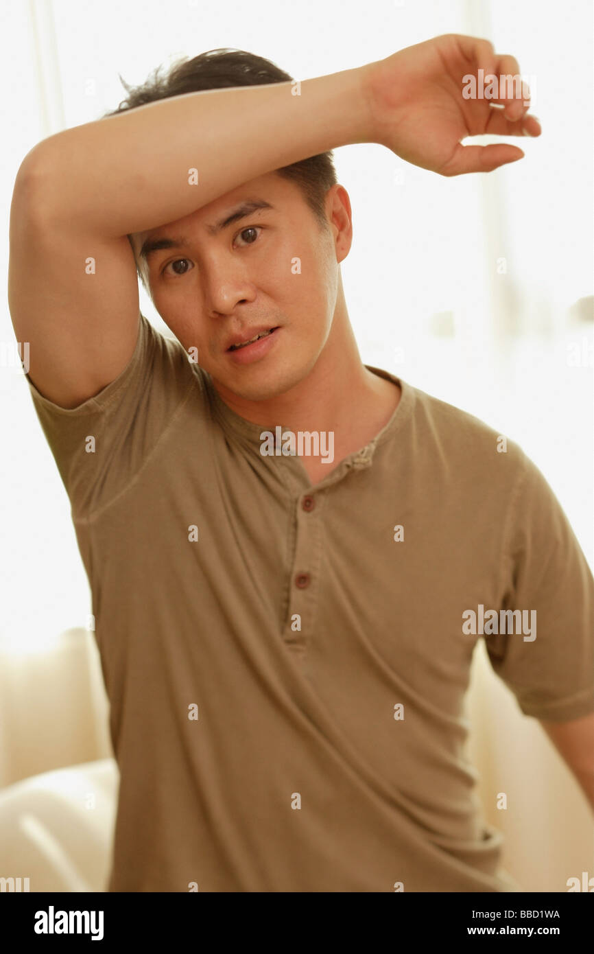 Man raising arm, looking at camera Stock Photo - Alamy