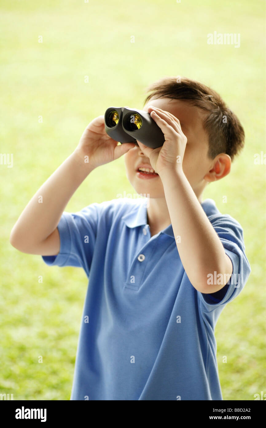 Young boy using binoculars Stock Photo - Alamy