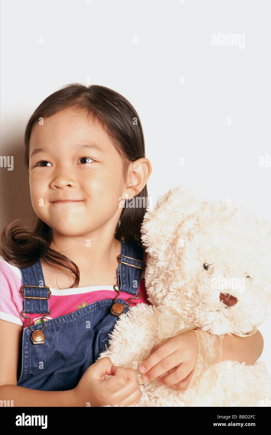 Young girl holding teddy bear, looking away Stock Photo - Alamy Young girl holding teddy bear, looking away Stock Photo - Alamy