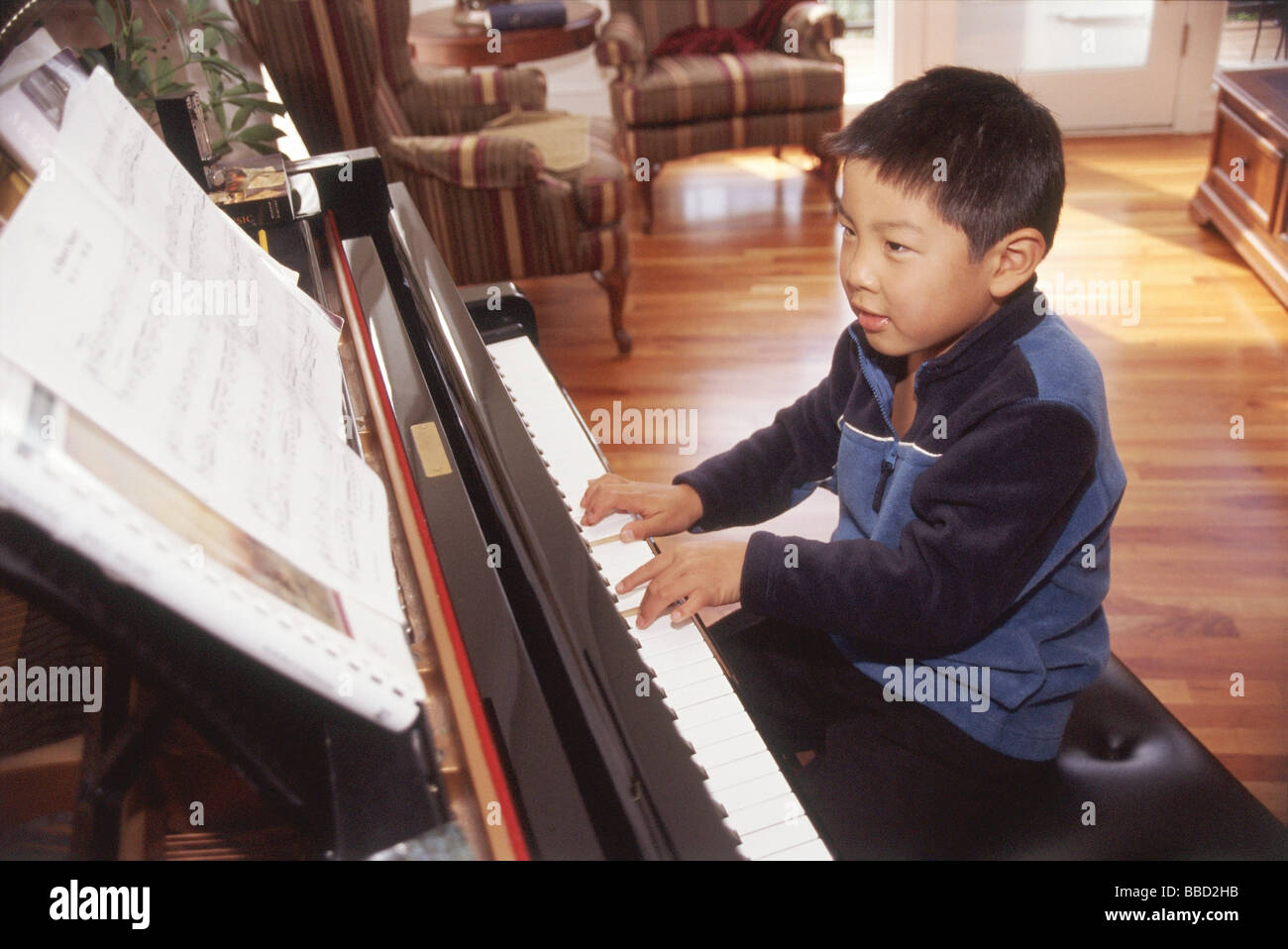 Boy playing the piano Stock Photo - Alamy