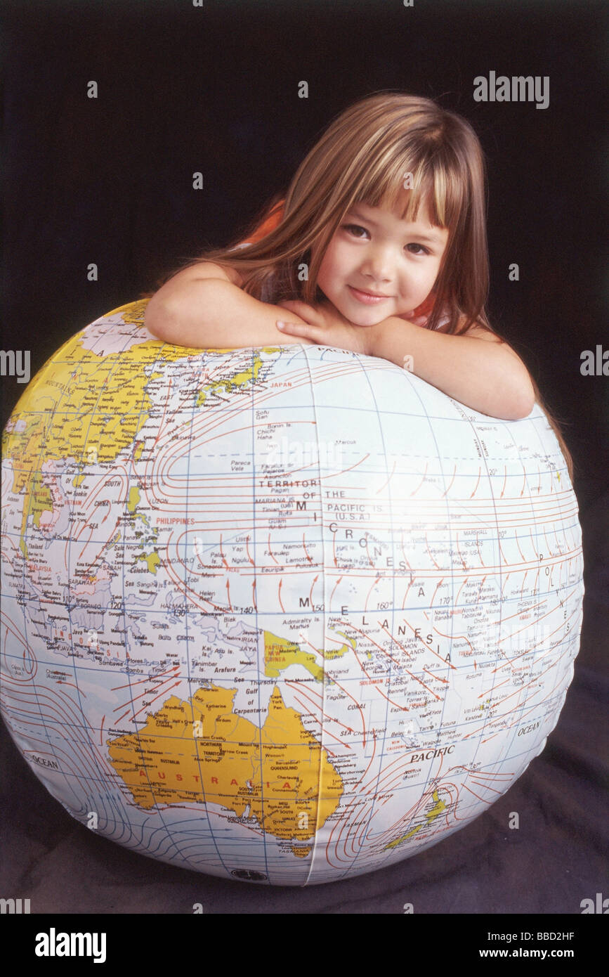 Girl leaning on globe Stock Photo - Alamy