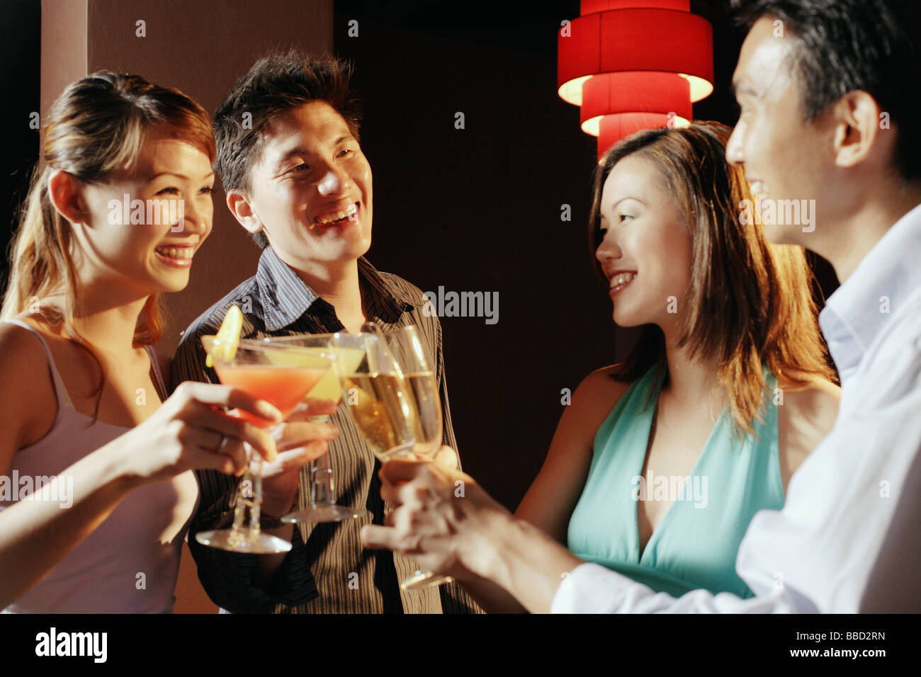 Couples with drinks, toasting Stock Photo - Alamy