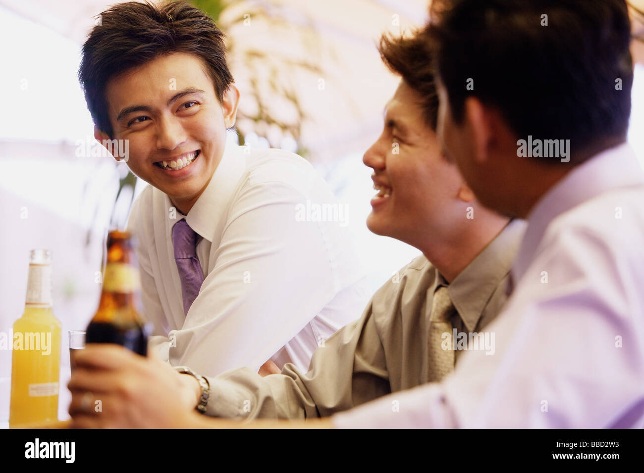Young men having drinks Stock Photo - Alamy