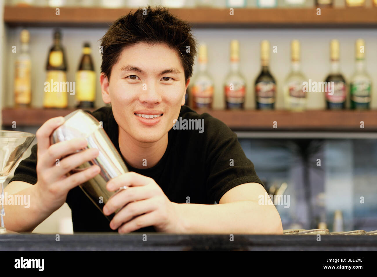 Man holding cocktail mixer Stock Photo - Alamy