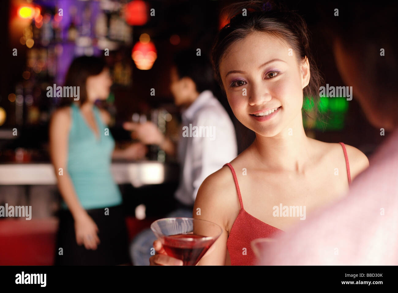 Woman facing man, looking over shoulder at camera Stock Photo - Alamy