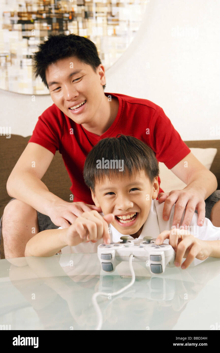 Father and son at home, boy holding game controller Stock Photo - Alamy