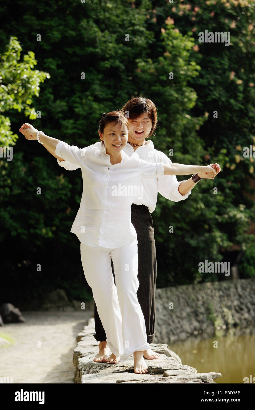 Couple walking along ledge hi-res stock photography and images - Alamy