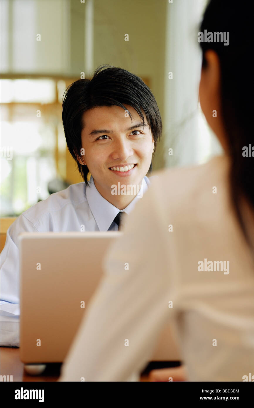 Man facing woman, over the shoulder view Stock Photo - Alamy