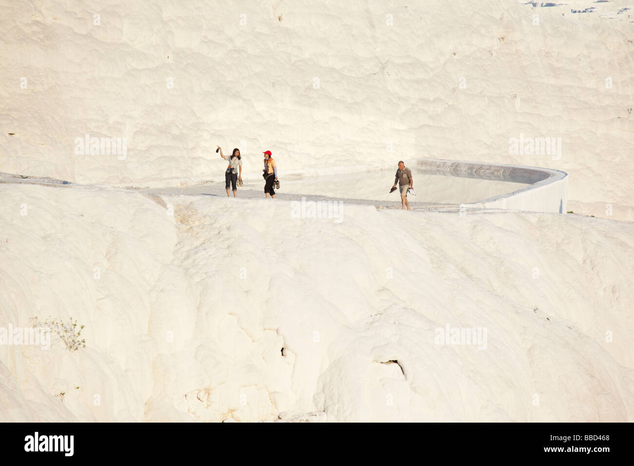 Tourists at the white mineral cliffs at Pamukkale in Turkey Stock Photo ...