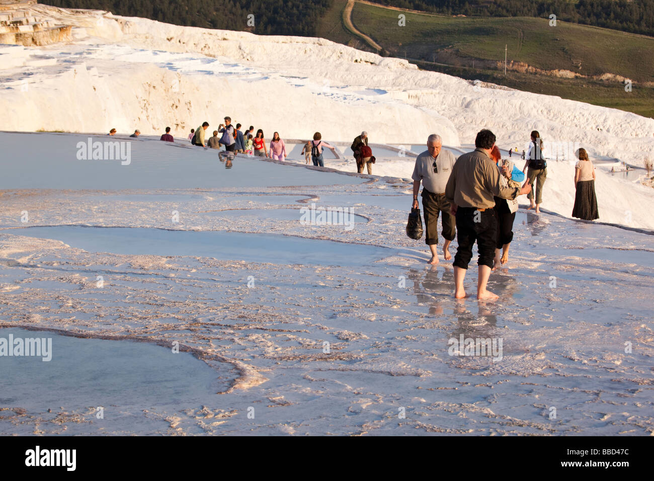Tourists at the white mineral cliffs at Pamukkale in Turkey Stock Photo ...