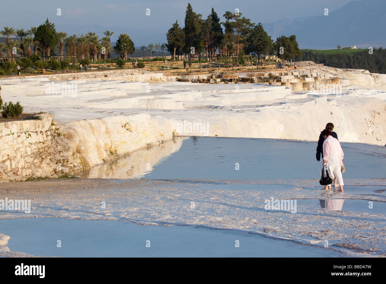 Tourists at the white mineral cliffs at Pamukkale in Turkey Stock Photo ...