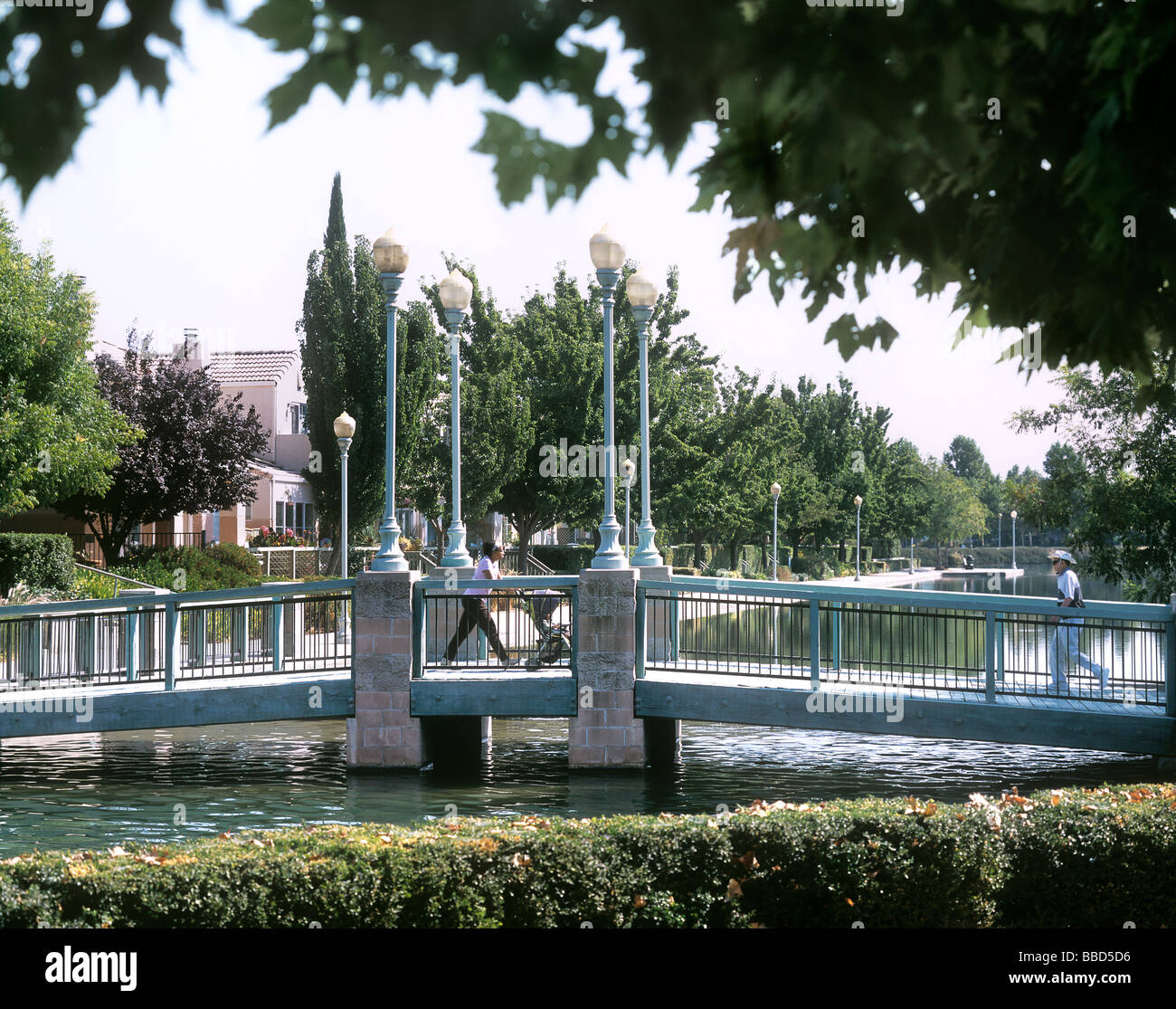 A footpath bridge over a lake in the new Laguna West development, a ...