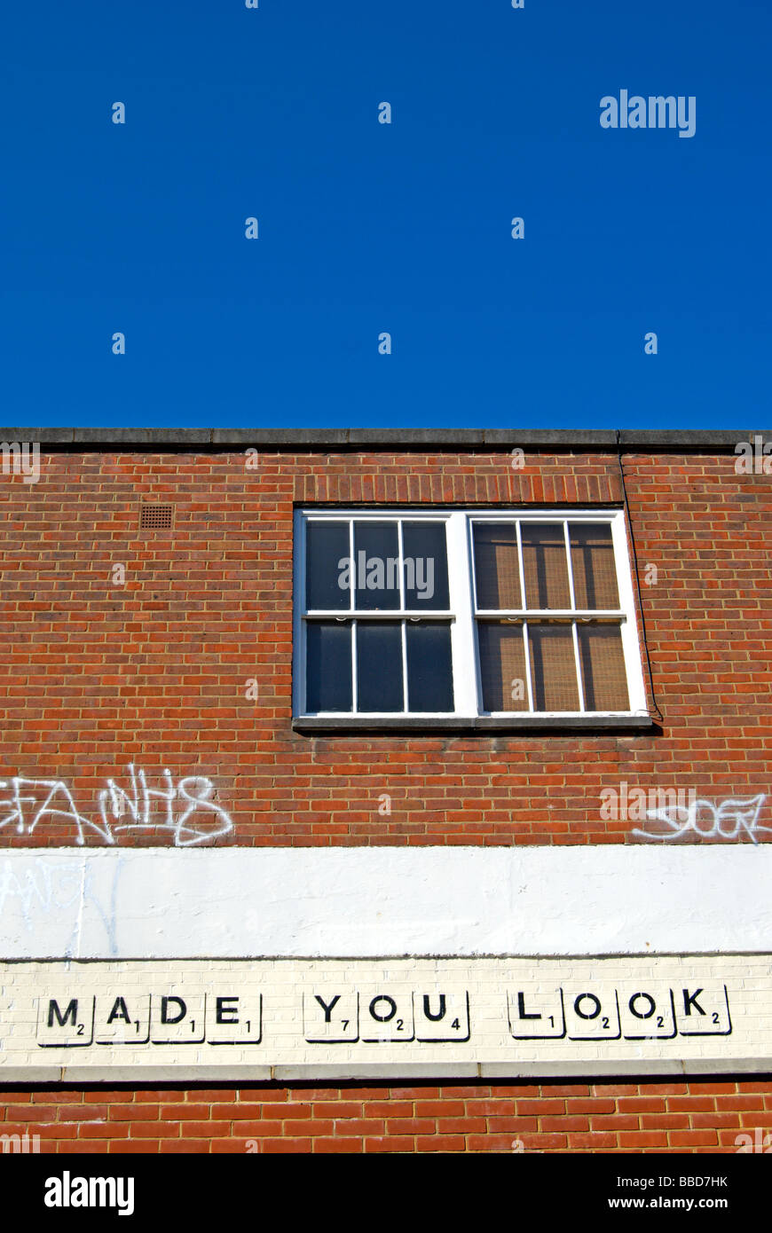 made you look written in scrabble letters stencilled onto brick ...