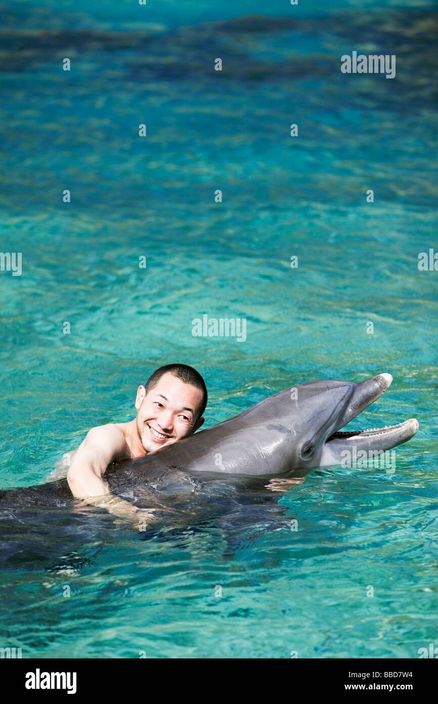 Swimming with dolphins in Moorea, French Polynesia (Tahiti Stock Photo ...