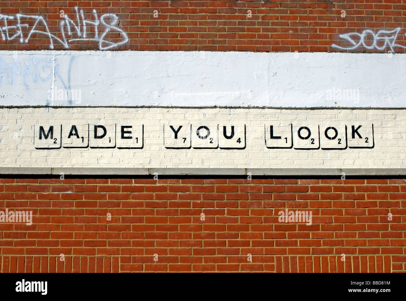 made you look written in scrabble letters stencilled onto brick ...