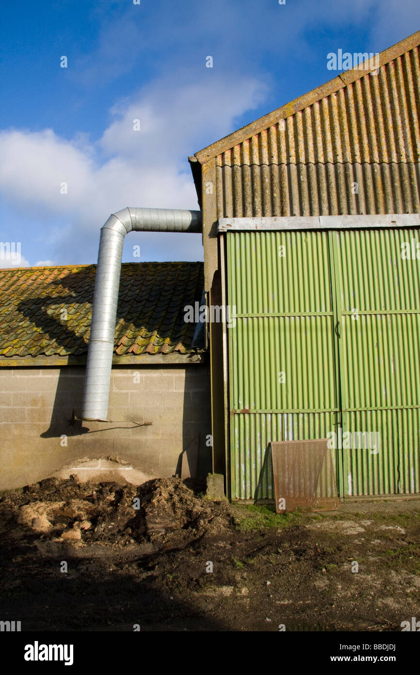 Farm buildings in Suffolk look slightly bizarre against a blue sky ...