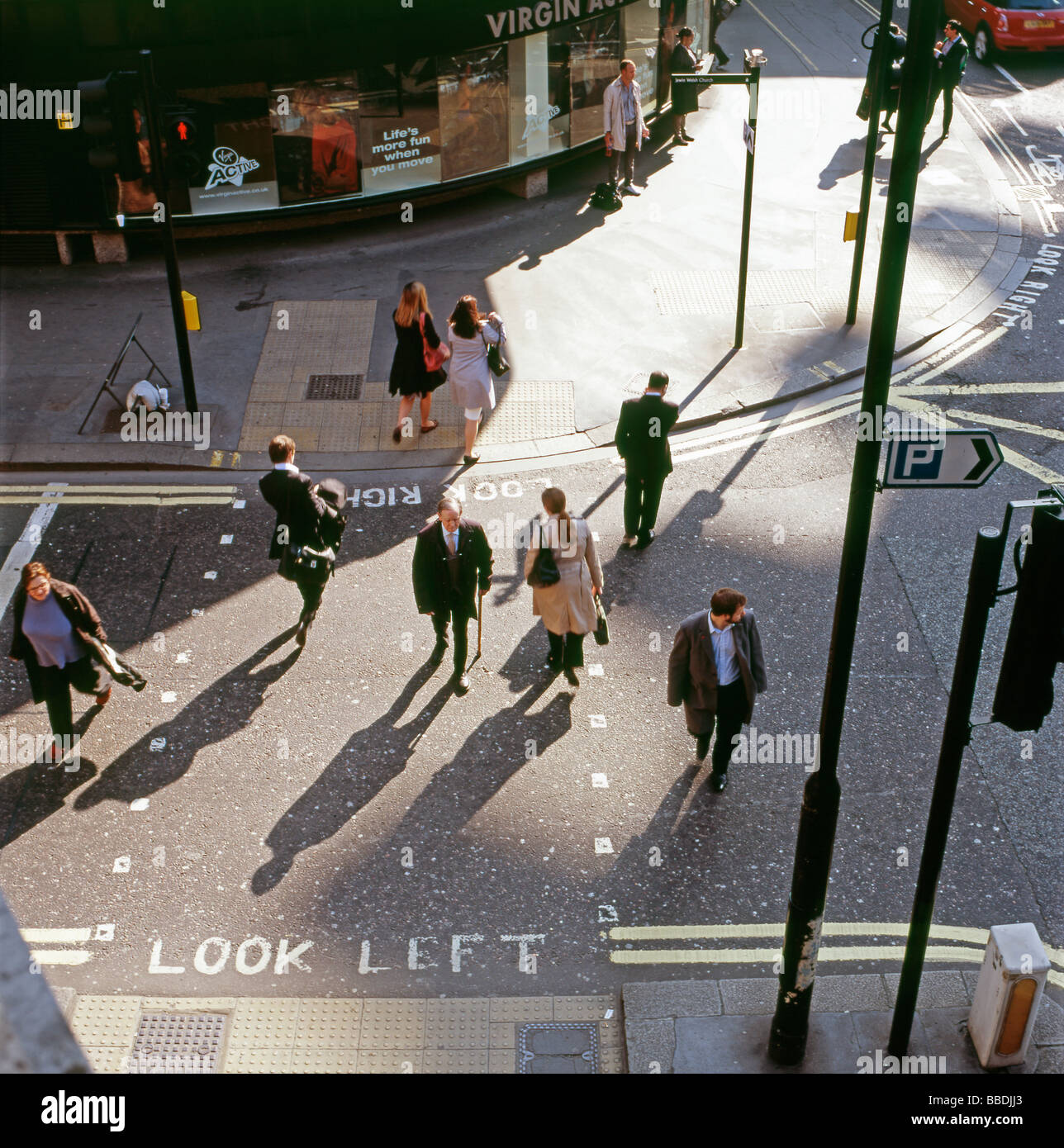 Pedestrians crossing at traffic lights intersection near the Barbican ...