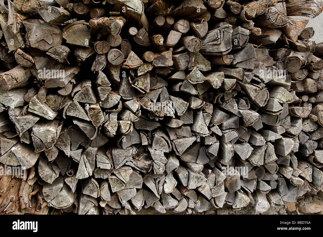 Wood stacked up outside House in Japan Stock Photo - Alamy