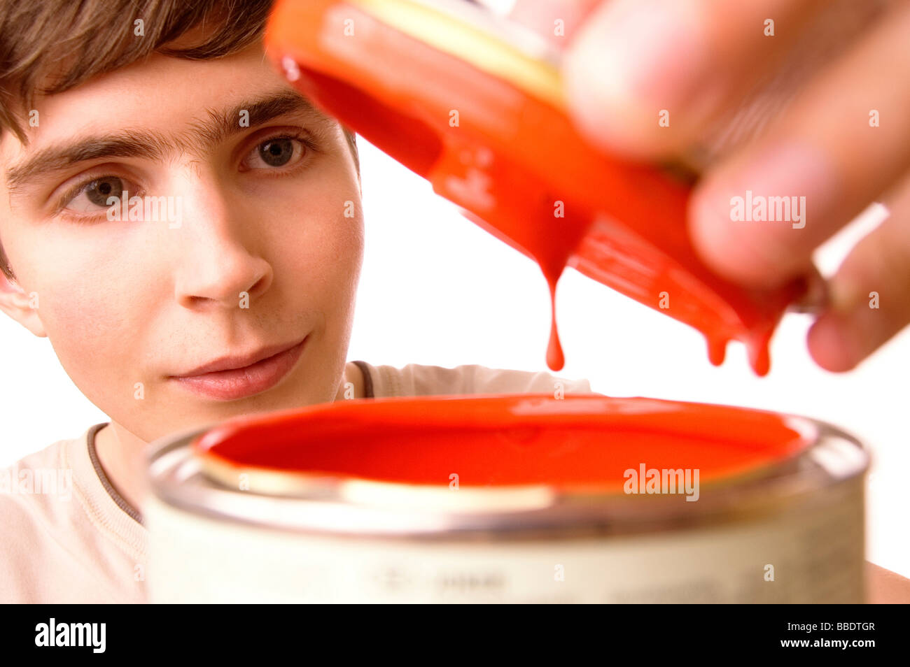 Young man opening paint can Stock Photo - Alamy