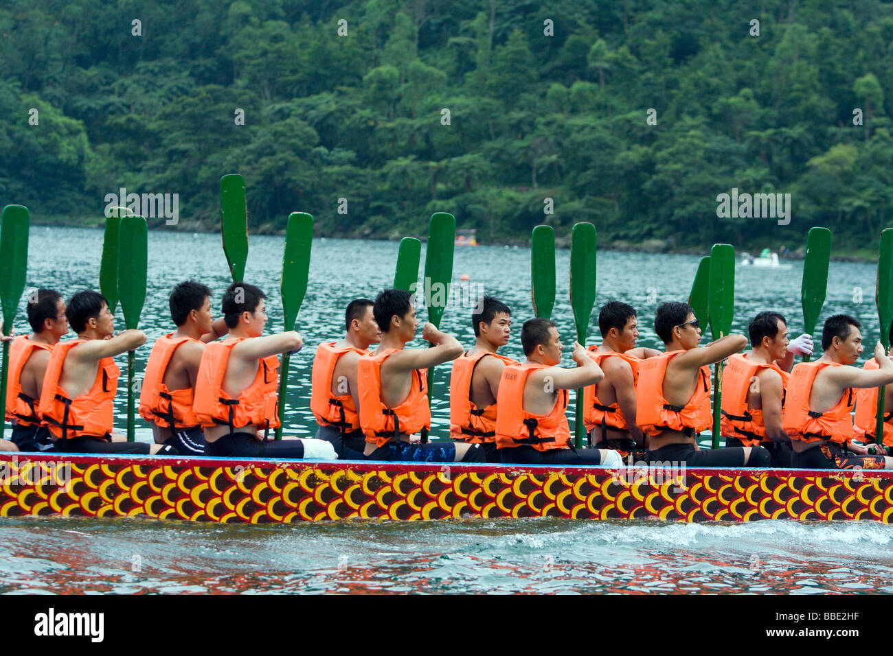 Dragon Boat Festival, rowing team competitors salute the spectators ...