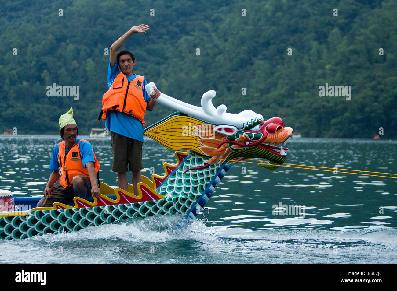 Dragon Boat Festival, rowing team competitor waves to spectators after ...