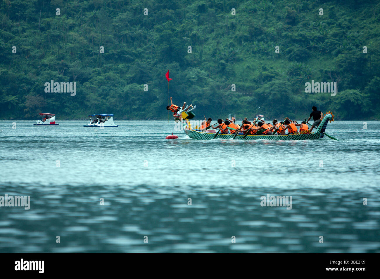 Dragon Boat Festival, flag catcher takes the flag during the dragon ...